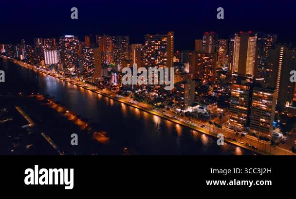 Lights reflect in the dark waterscape of the Ala Wai Canal outlining ...
