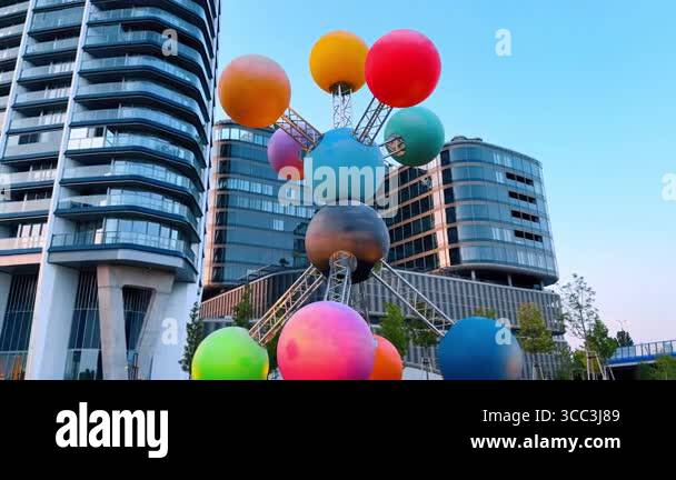 Colorful spheres in urban landscape. A vibrant sculpture of spheres ...