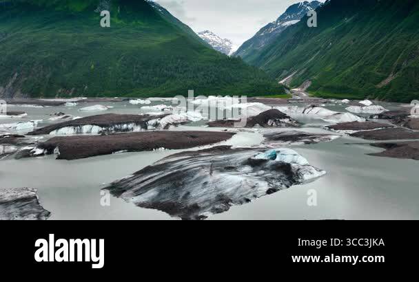 Blocks of ice stick out from the river in Alaska. Amazing green ...