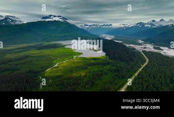 Picturesque valley with a river among the spectacular mountains. Grey ...
