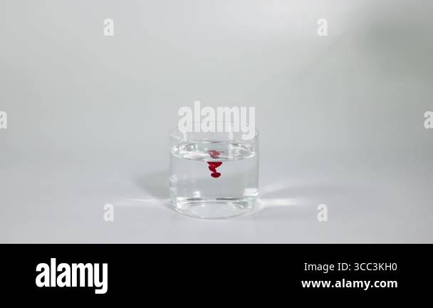 Sequential ink drops dispersing in a clear water glass Stock Video ...