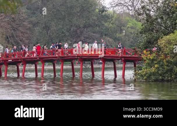 Crowd crossing iconic red bridge over water Stock Video Footage - Alamy