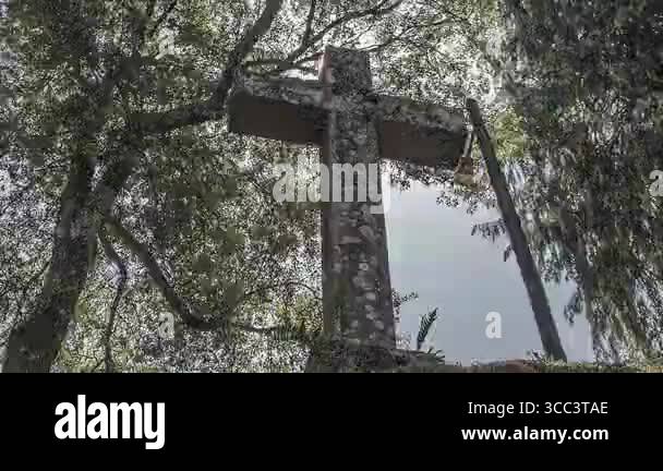 Low angle view wide shot of christian cross at forest landscape zoom ...