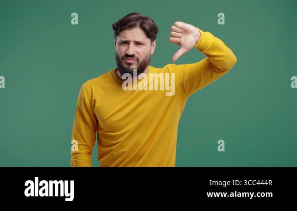 Mature bearded man expresses disapproval with thumbs down gesture and ...