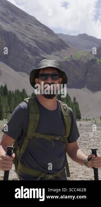 Vertical. Confident caucasian man hiking in scenic mountain setting ...