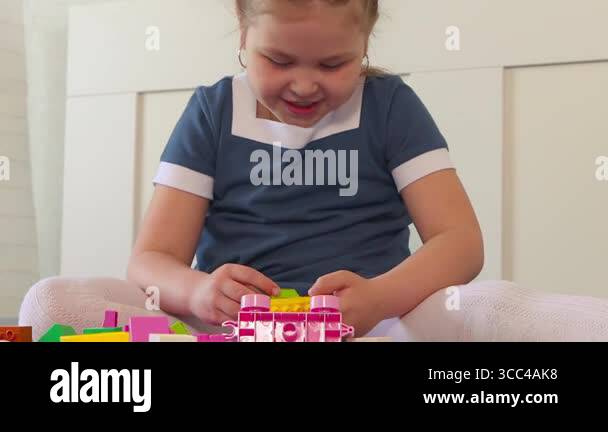 Toddler explores texture and color through hands-on play with blocks ...