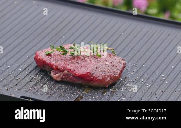 outdoor cooking. cook preparing fresh beef fillet mignon steak with ...