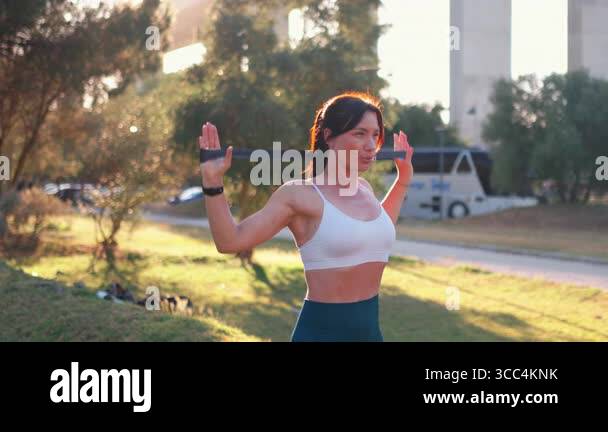 Outdoor fitness session with resistance band in park on sunny day ...