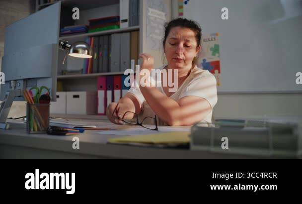 Exhausted Female Teacher Sitting at Computer in Empty Classroom, Having ...
