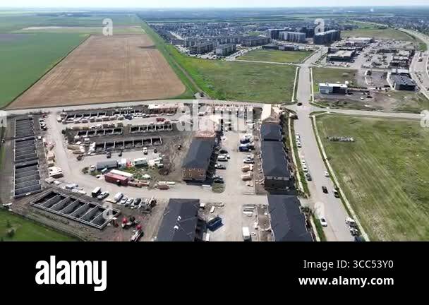 View of a city with a large empty lot in the middle. The lot is ...