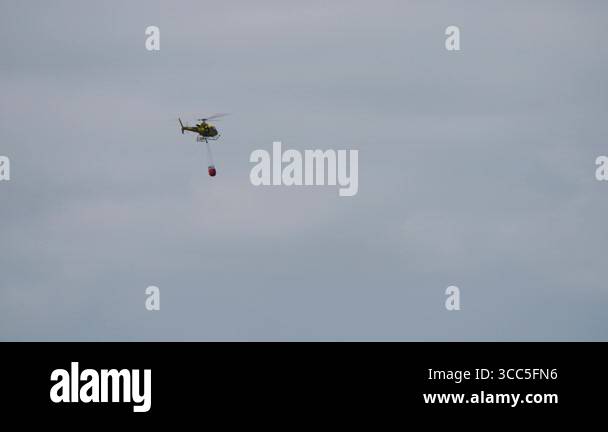 Yellow firefighting helicopter carrying red Stock Videos & Footage - HD ...