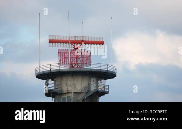 Detailed view of airport radar system with red rotating antenna mounted ...
