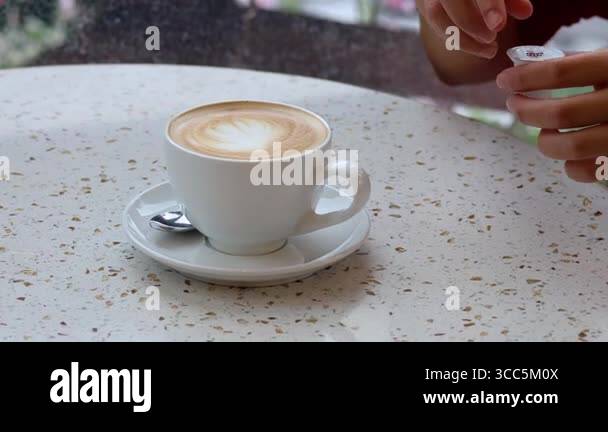 Person adding sugar syrup to a latte Stock Video Footage - Alamy
