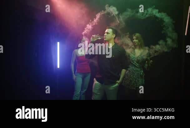 Young adults enjoying a night out, dancing and drinking at a vibrant ...