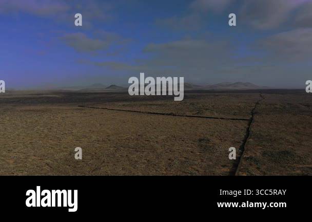 Brown, dry volcanic sandy fields stretch endlessly, shaping ...