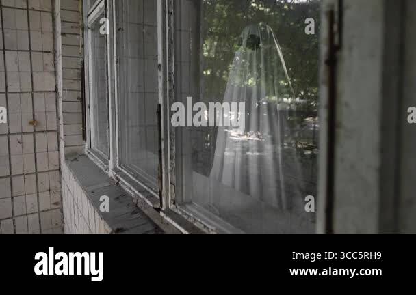 Ghost standing near the window in haunted house. Halloween concept ...