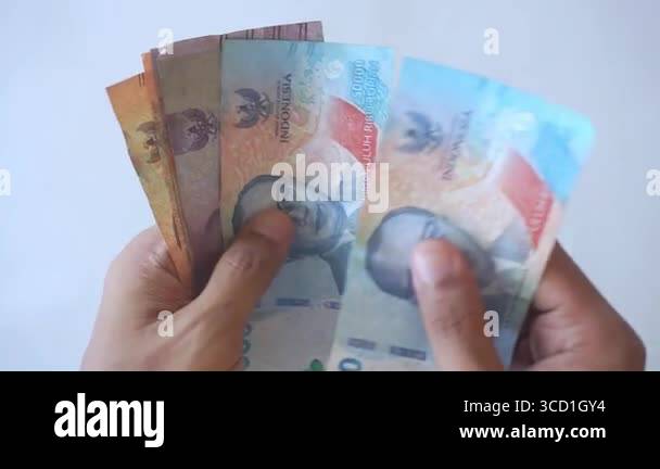 Hand gesture of counting Indonesian rupiah banknotes, closeup Stock ...