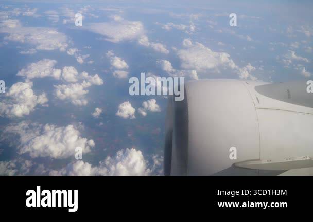 Jet Engine and Fluffy Clouds From Airplane at Cruising Altitude During ...