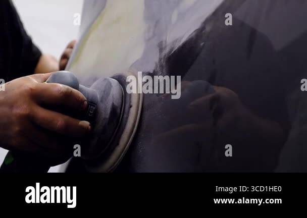 Mechanic cleaning a car wheel at an auto repair workshop in slow motion ...