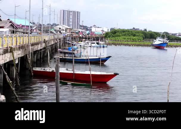 Traditional fishing activities using wooden boats on the Manggar River ...