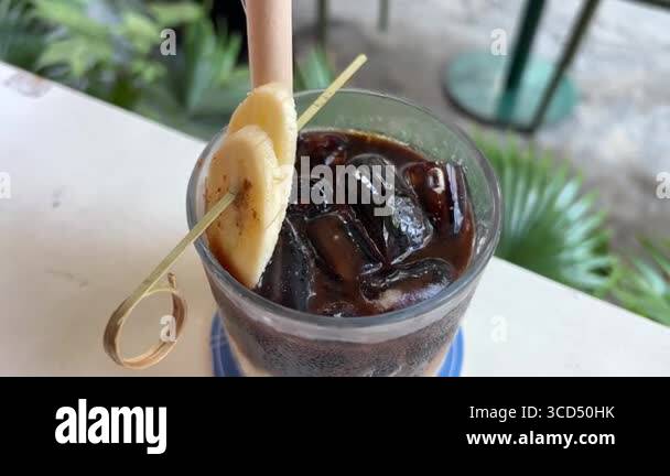 Iced coffee banana Black coffee with ice. Making iced coffee. Vertical ...
