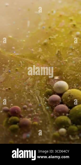 Vertical video. Marble fluid. Drop emulsion. Fantasy dissolving yellow ...