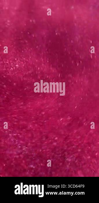 Vertical video. Shimmering flow. Shiny fluid. Defocused pink color ...