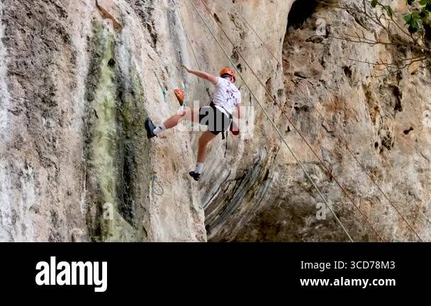 Climber scaling limestone cliffs with support team Stock Video Footage ...
