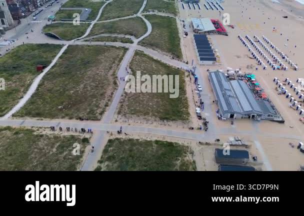 Aerial view of a sandy beach with people relaxing and walking near ...