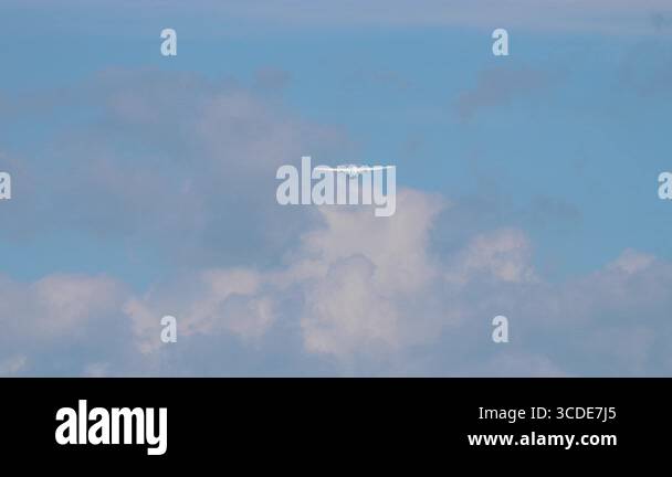 Footage of airplane gaining altitude in blue cloudy sky, rear view ...