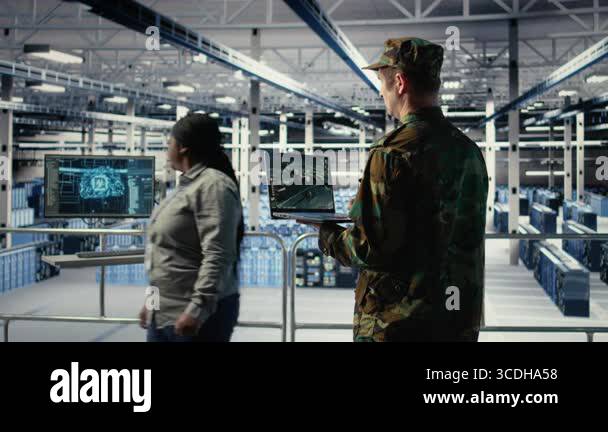 Military engineer in data center tracking satellite coordinates using ...