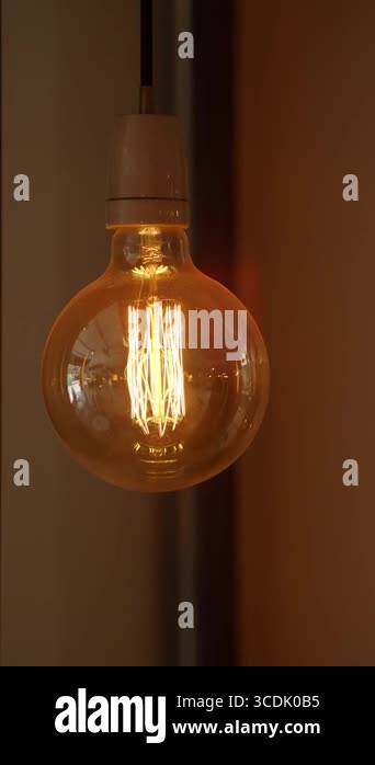 A warm bulb glows in a dim room, creating a welcoming vibe Stock Video ...