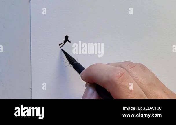 Close-up of a hand using a brush to create the initial strokes of an ...