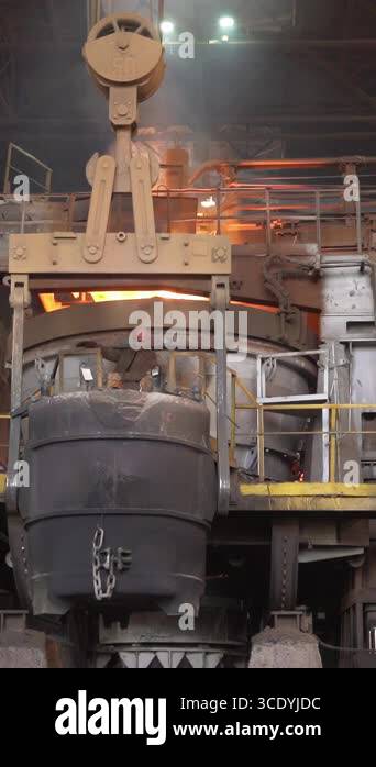 Molten metal transported by an industrial crane in a steel mill Stock ...