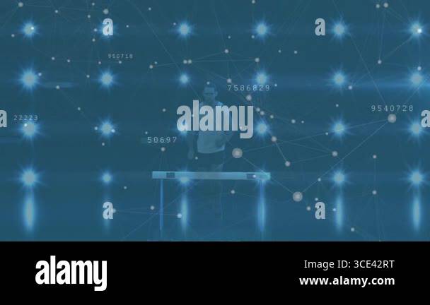 Male athlete stepping sprinting and jumping over hurdle under glowing ...