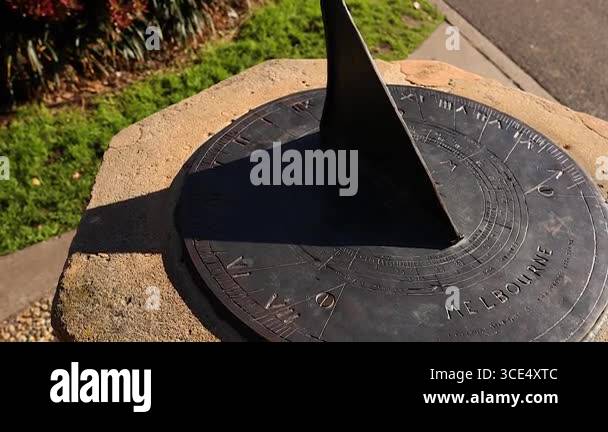Sundial casting shadow in Melbourne park Stock Video Footage - Alamy