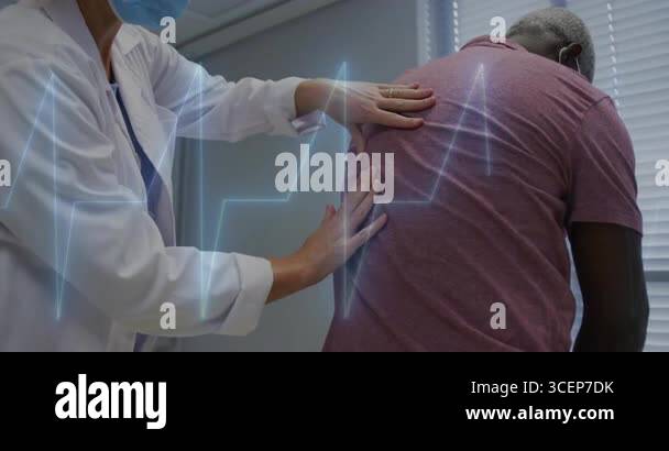 Female physician placing hands on male patient back and palpating with ...