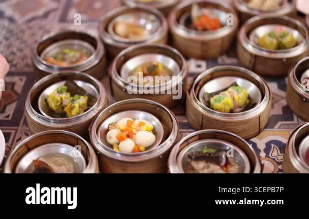 Assorted dim sum dishes displayed on a table Stock Video Footage - Alamy