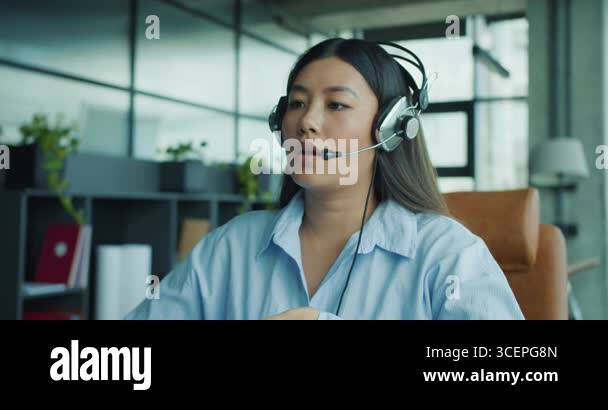 A young woman in a headset is engaged in a meaningful conversation in a ...