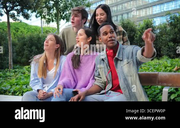 A cheerful group of friends laughing and pointing, capturing a joyful ...