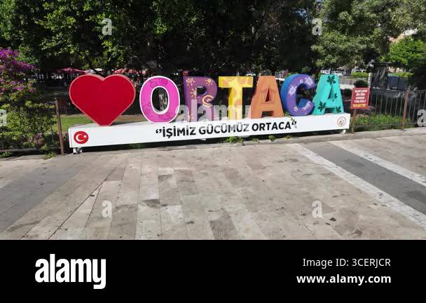 Colorful Ortaca sign with Turkish text and heart symbol in public park ...
