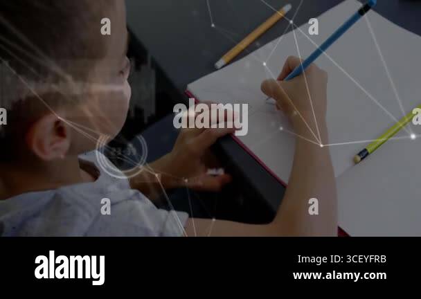 Boy touching pencil tip to notebook sketching geometry in learning as ...