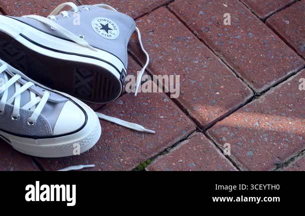 Classic Converse Sneakers on Brick. Iconic Casual Footwear. Laid-back ...
