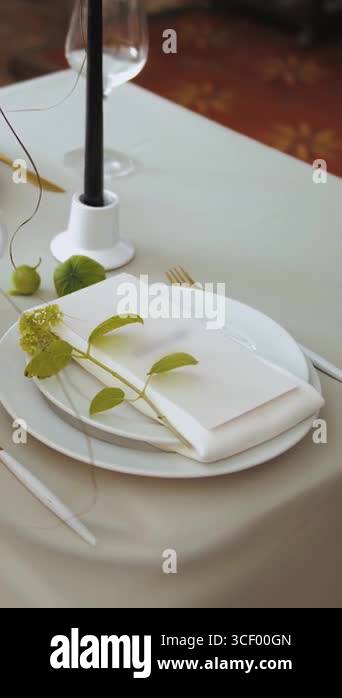 Table setting at a wedding or event, white plate with napkin, candles ...