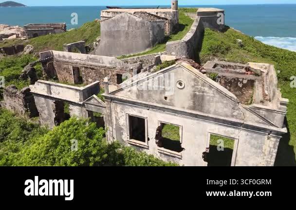 Orbital drone aerial scene of an old abandoned brick and stone fortress ...