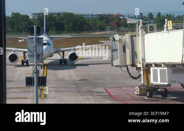 View from an airport terminal window of a commercial aircraft parked at ...