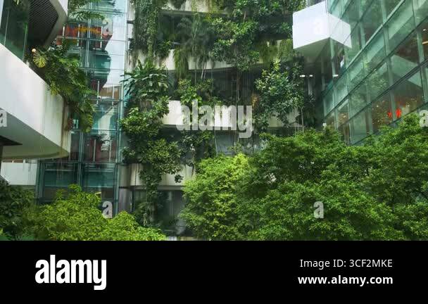 Modern eco-friendly shopping mall building facade with vertical garden ...
