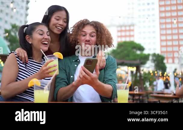 Young friends sharing laughter and good times while browsing social ...