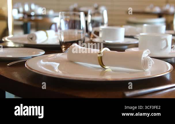 Close-up of an elegant table setting with plates with a fork and knife ...
