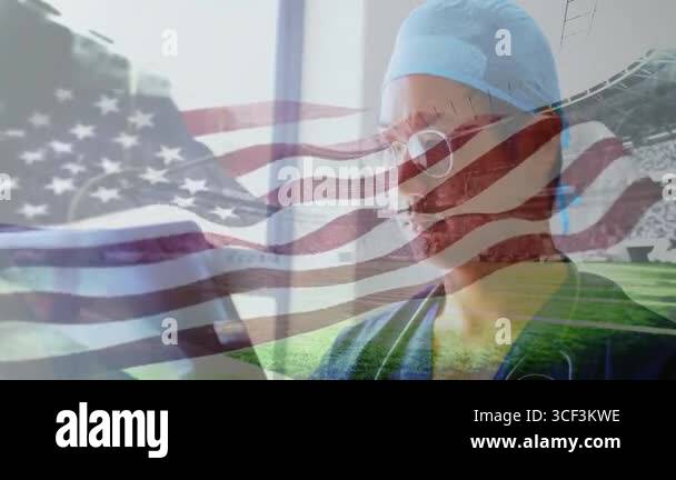 With stadium flag overlay pulsing male doctor reviewing patient chart ...